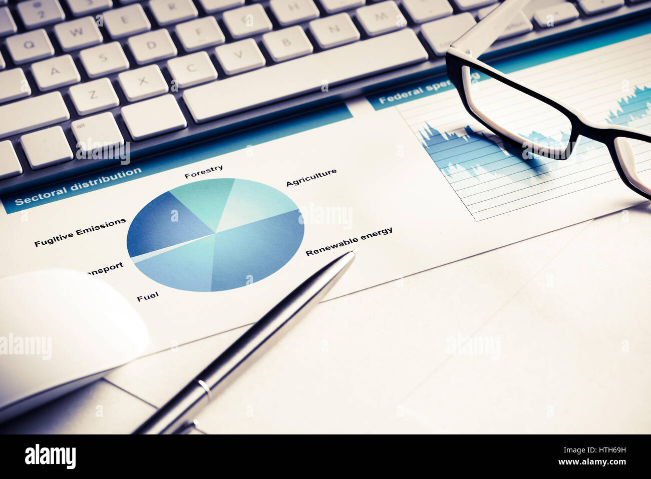 Business workplace with keyboard mouse and papers with graphs and ...