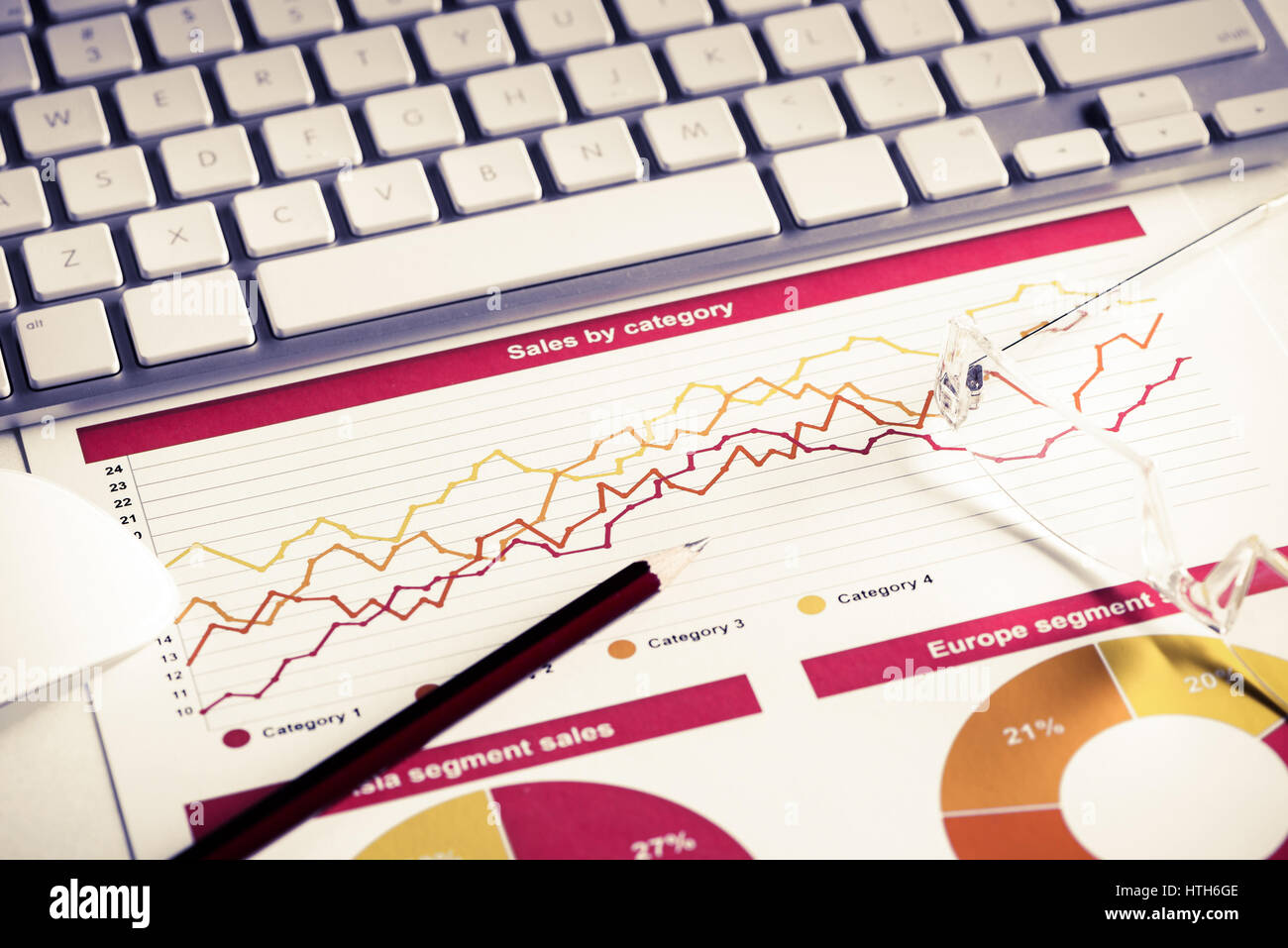Business workplace with keyboard mouse and papers with graphs and ...