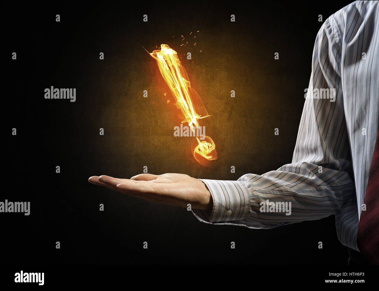 Glowing exclamation mark symbol in palm on dark background Stock Photo ...