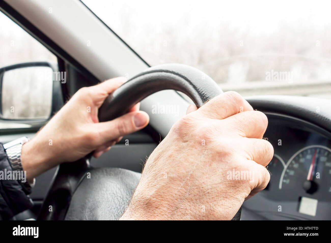 Men hands on the wheel of a car Stock Photo - Alamy