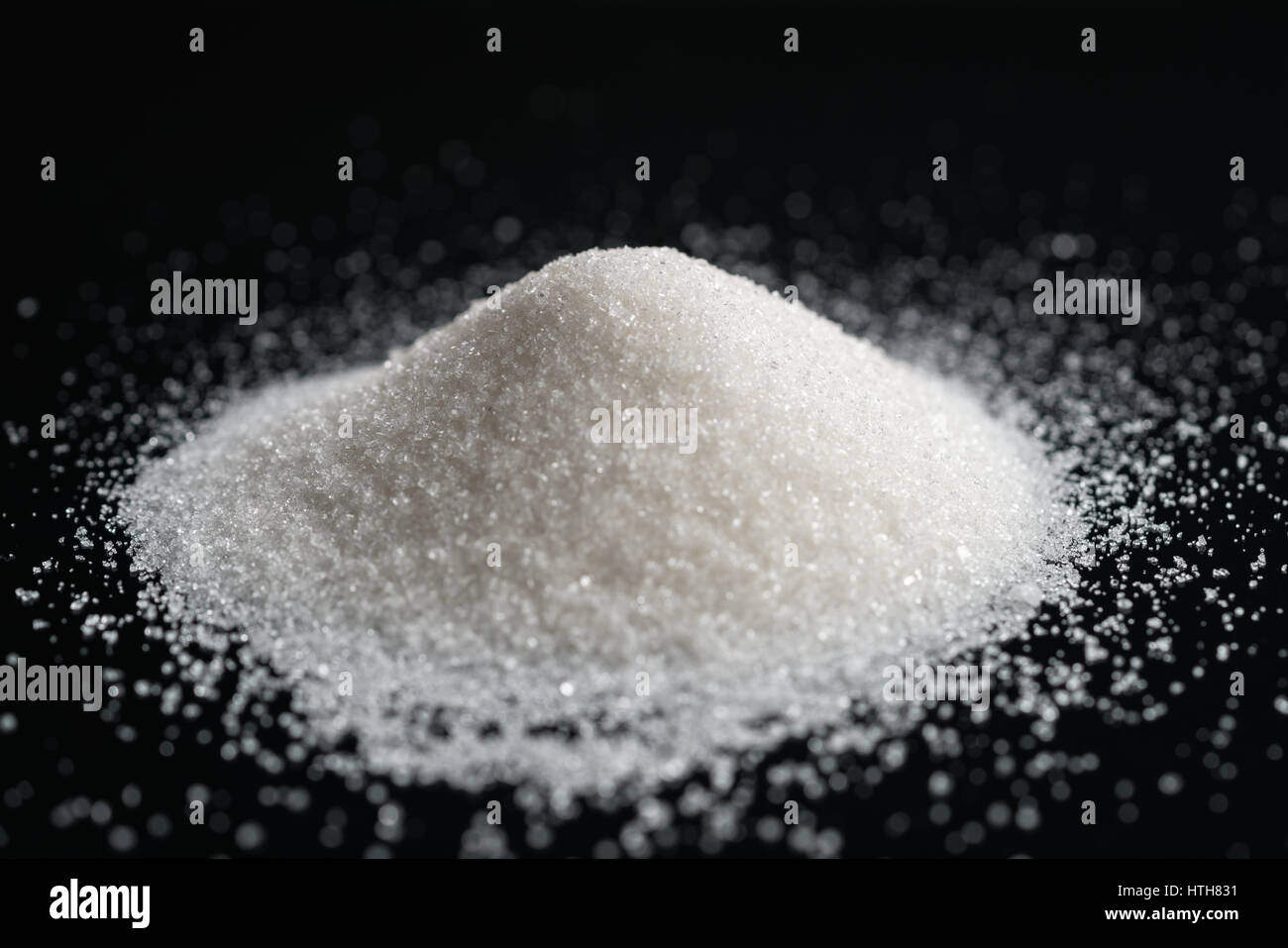 sugar pile on black background, closeup photo Stock Photo - Alamy
