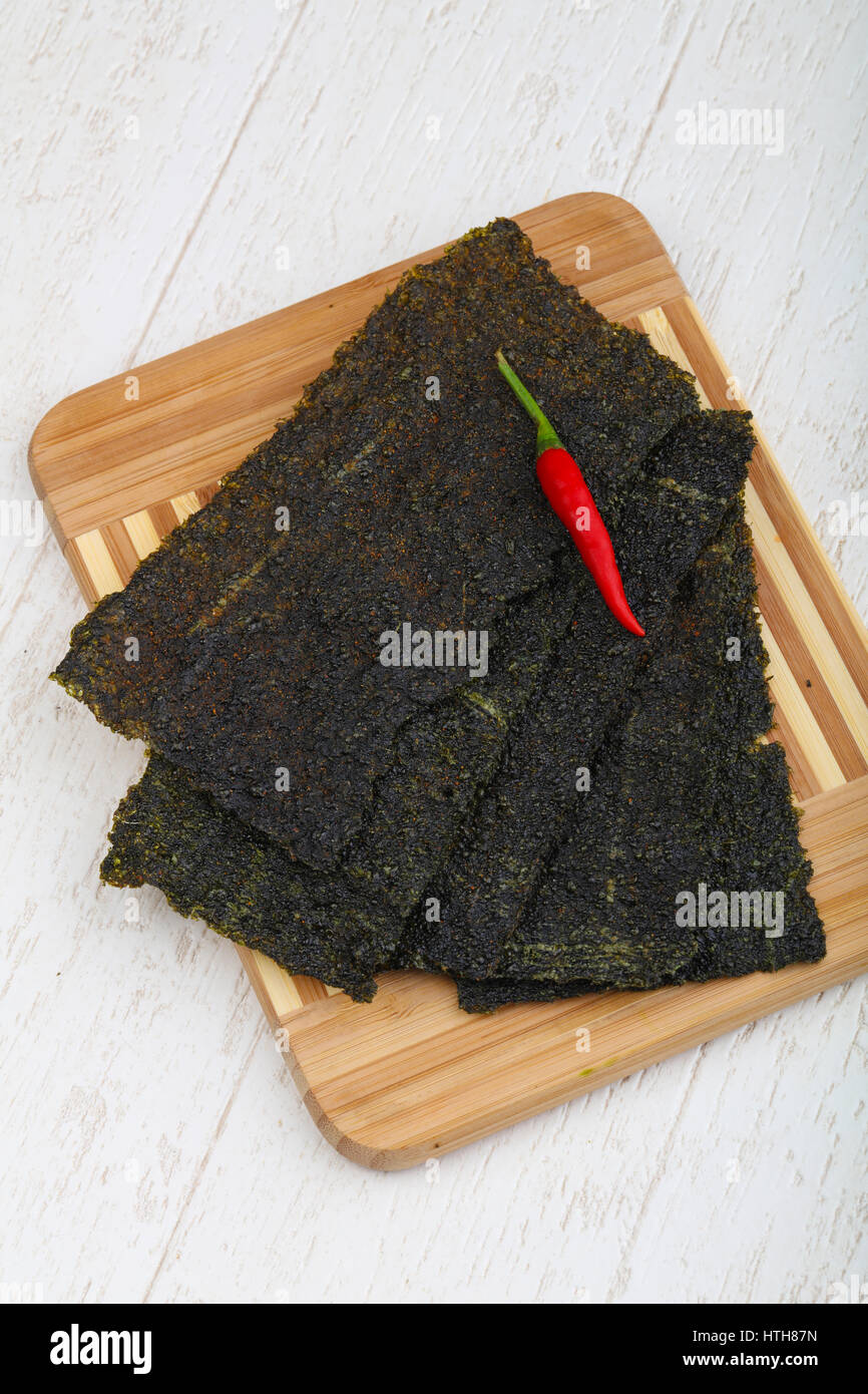 Spicy Nori seaweed sheets with pepper on wood Stock Photo - Alamy