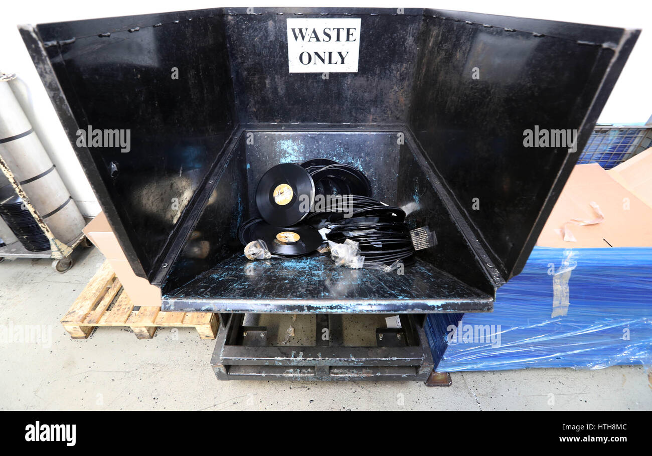 Waste vinyl material that cannot be recycled is placed in a bin at the ...