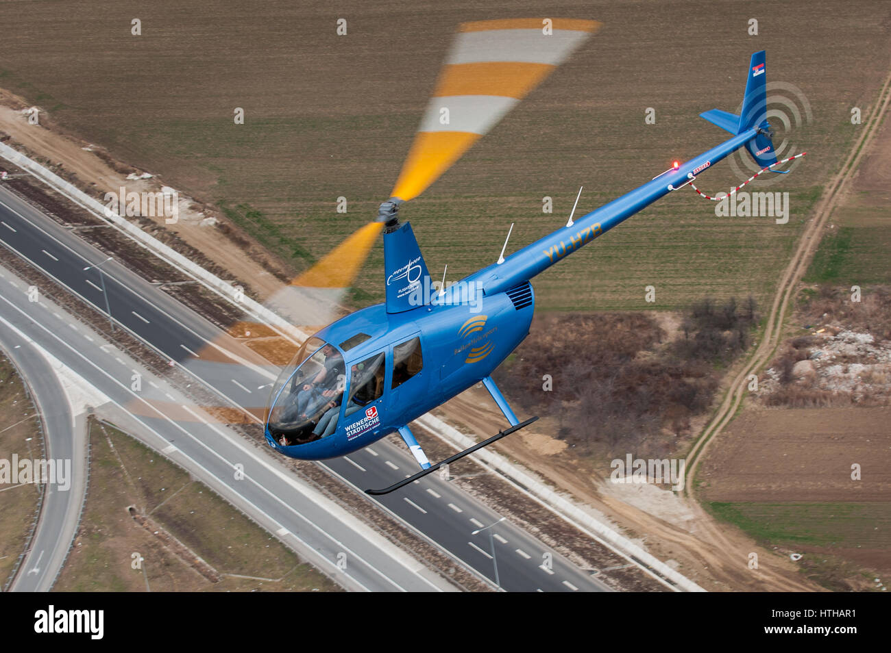 Robinson R44 light helicopter operated by Balkan Helicopters in flight ...