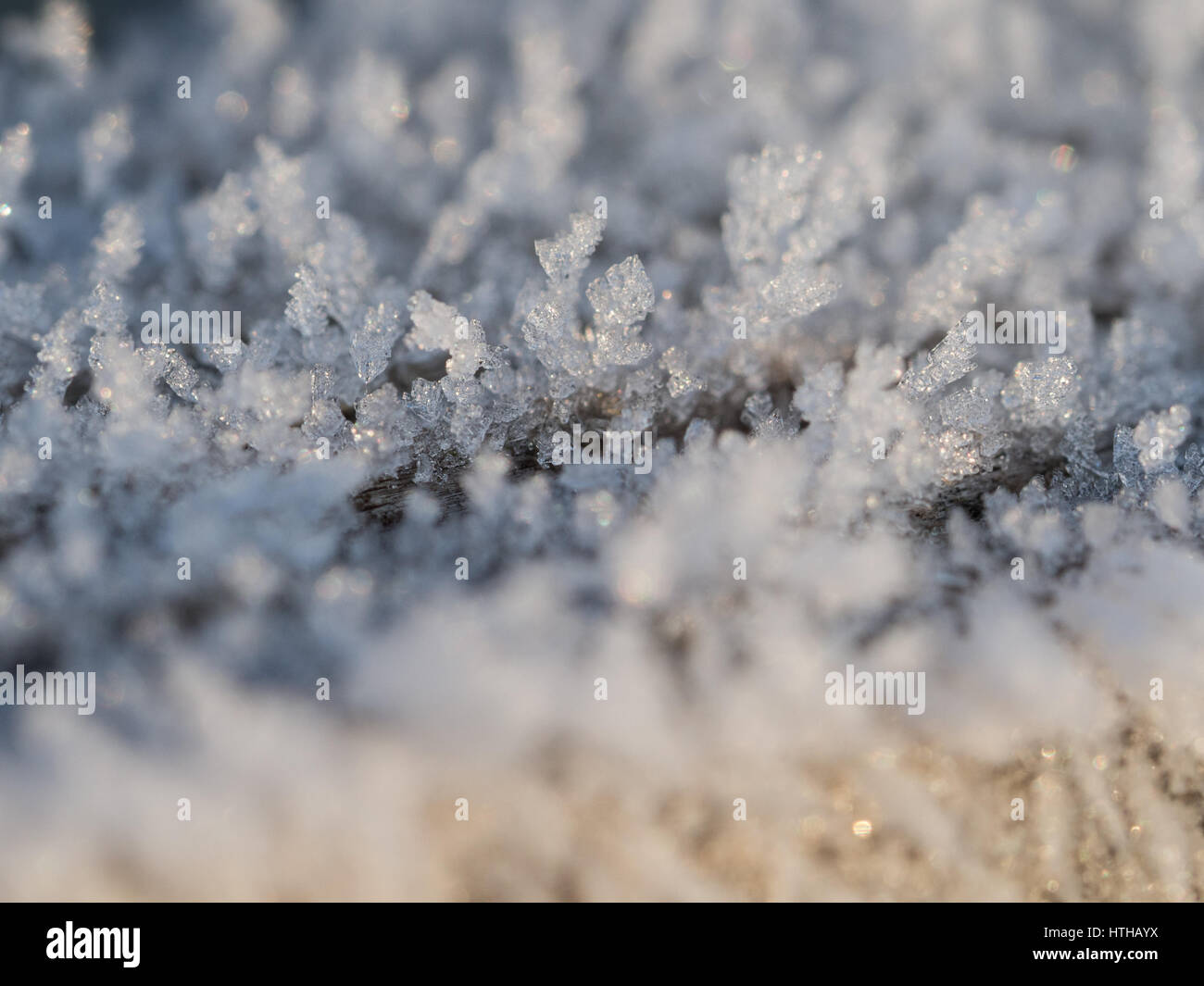 ice crystal formation spikes and shapes on a piece of timber on a cold ...