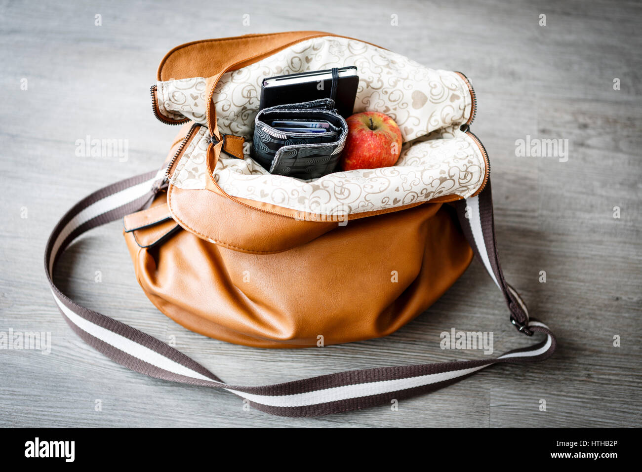 inside woman leather handbag on the wooden floor Stock Photo - Alamy