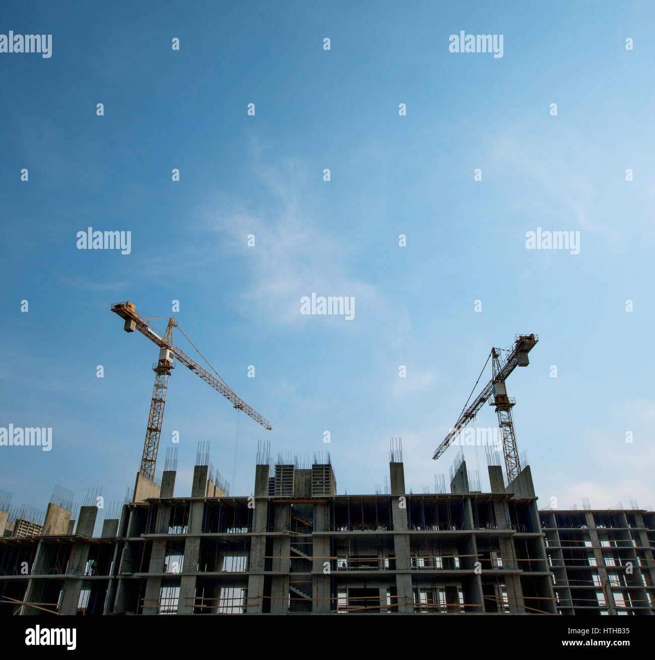 two tower crane working on building Stock Photo - Alamy