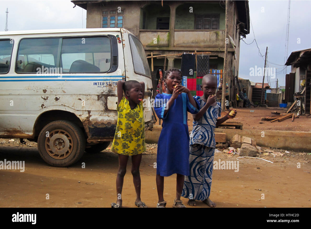 Three girls from Nigeria posing for a portrait in the middle of the ...
