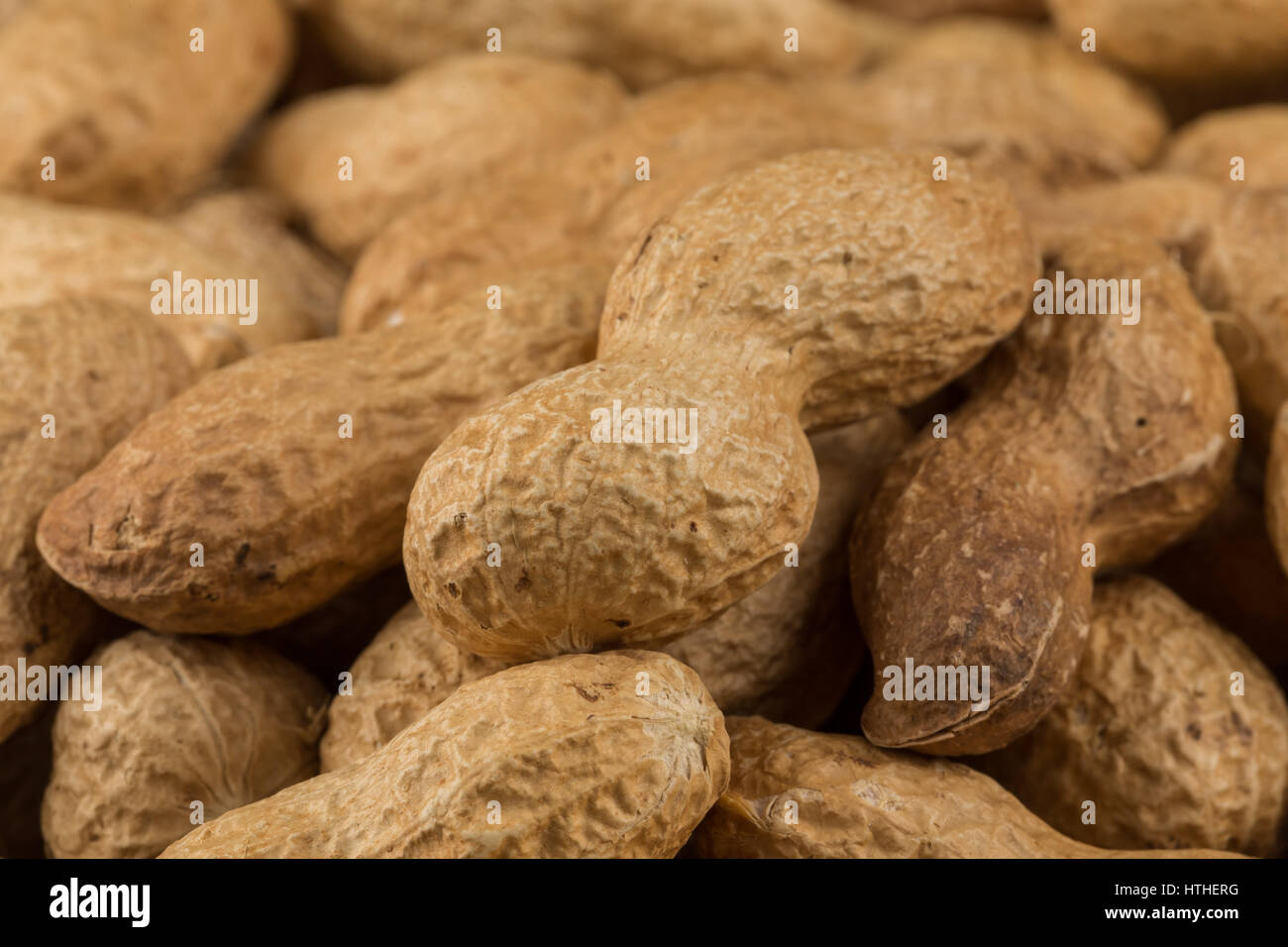 Pile of peanuts shells close up for background Stock Photo - Alamy