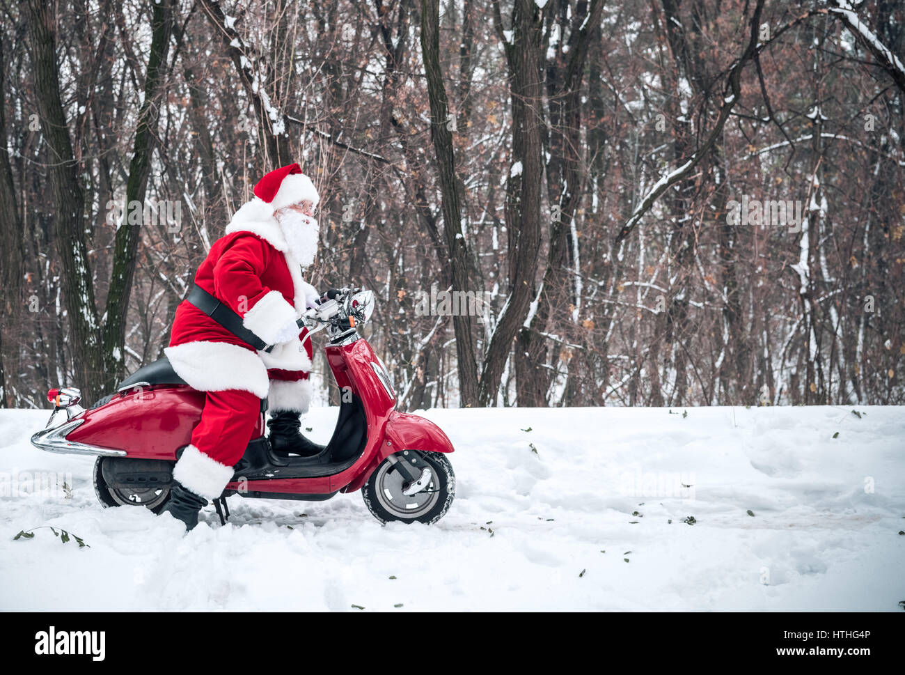 Santa Claus riding on scooter Stock Photo - Alamy