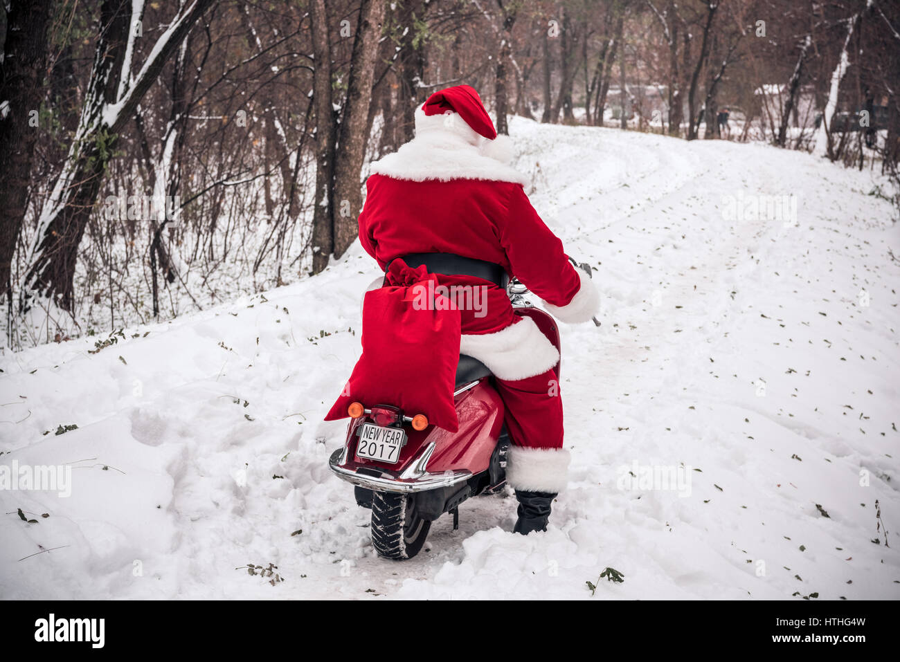 Santa Claus riding on scooter Stock Photo - Alamy