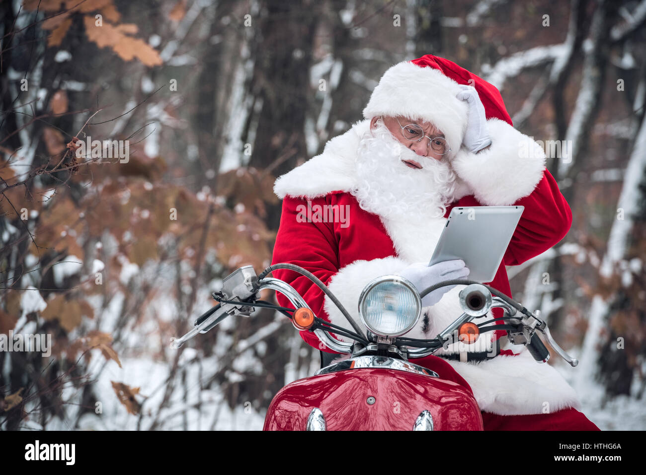 Santa claus on scooter hi-res stock photography and images - Alamy