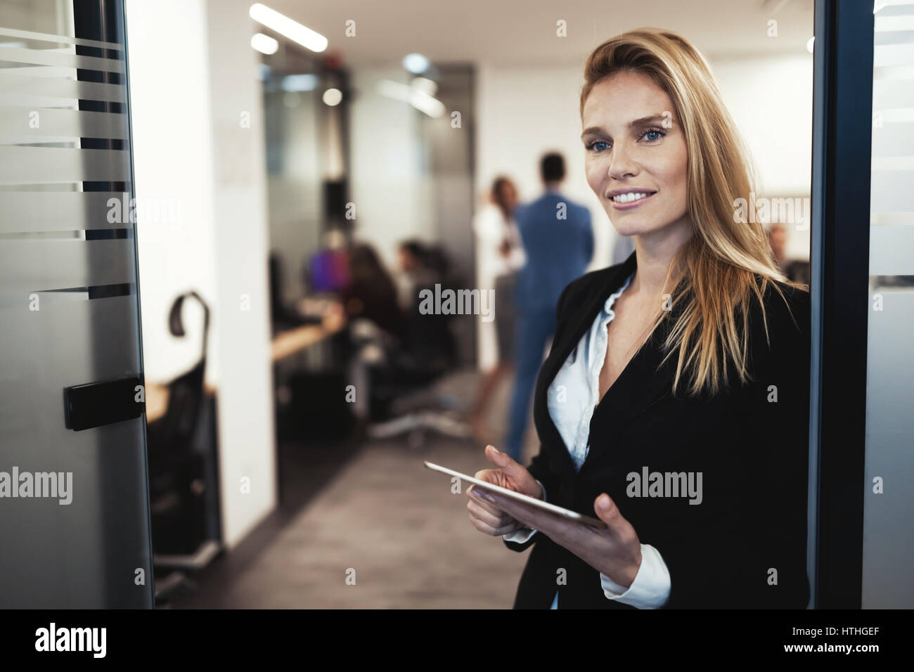 Business woman using tablet at workplace in the office Stock Photo - Alamy