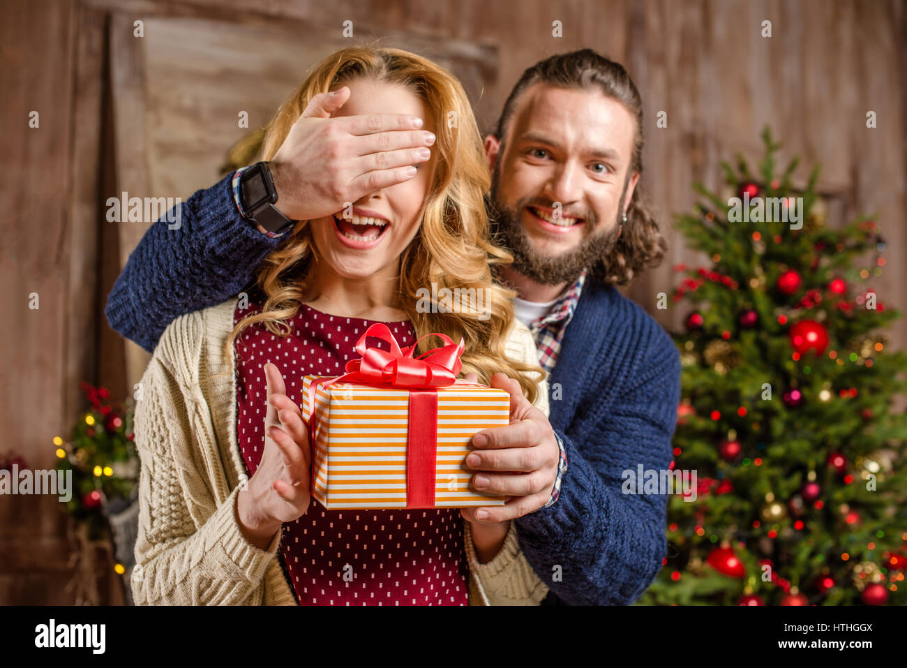 Man presenting gift box to woman Stock Photo - Alamy