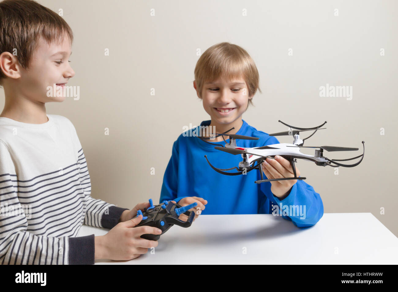 Happy kids playing with drone at home Stock Photo - Alamy