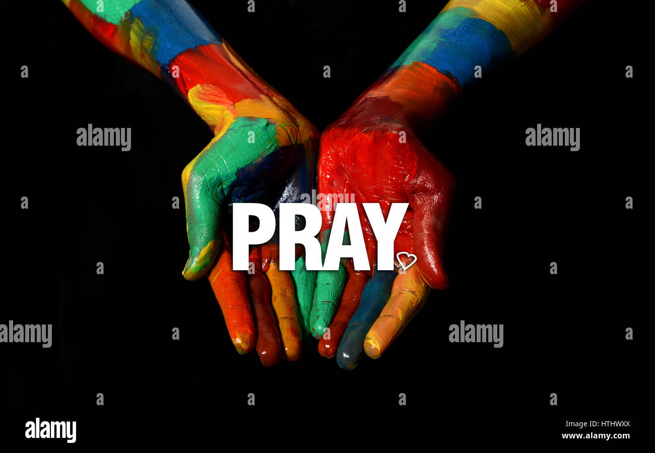 Pray concept on Multi Colors Painted hand Stock Photo - Alamy