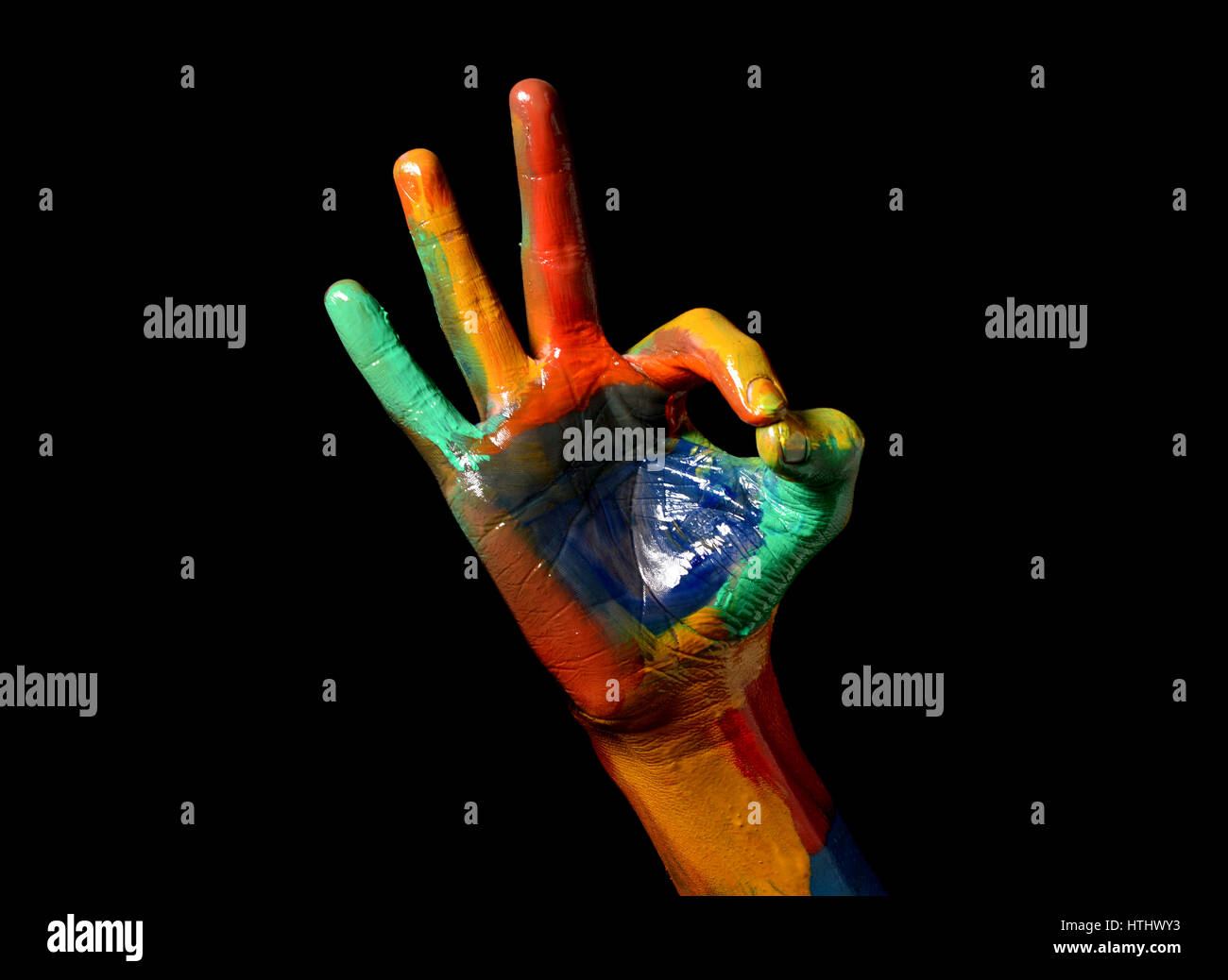 Colorful painted hand showing Good sign Stock Photo - Alamy