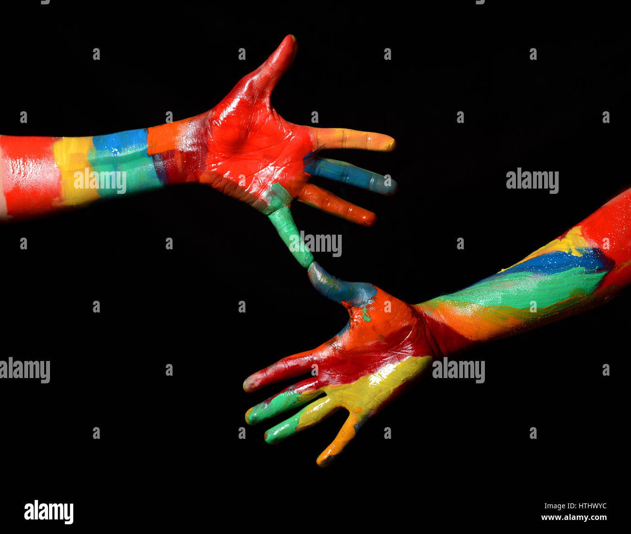 Two Oil Painted Hands meeting up Stock Photo - Alamy