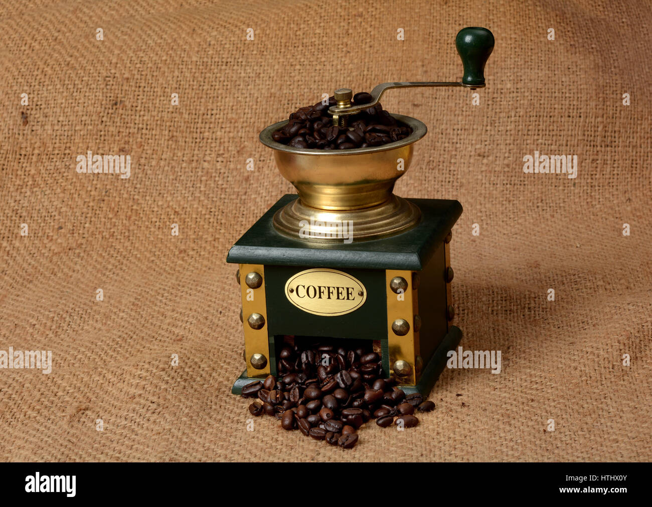 Coffee Beans filled in retro grinder Machine on jute fabric Stock Photo ...