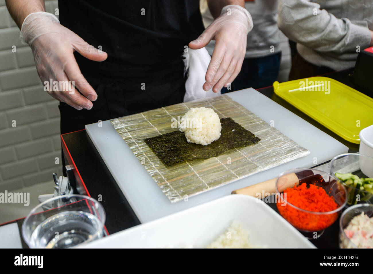 Human hands cooking sushi rolls hi-res stock photography and images - Alamy
