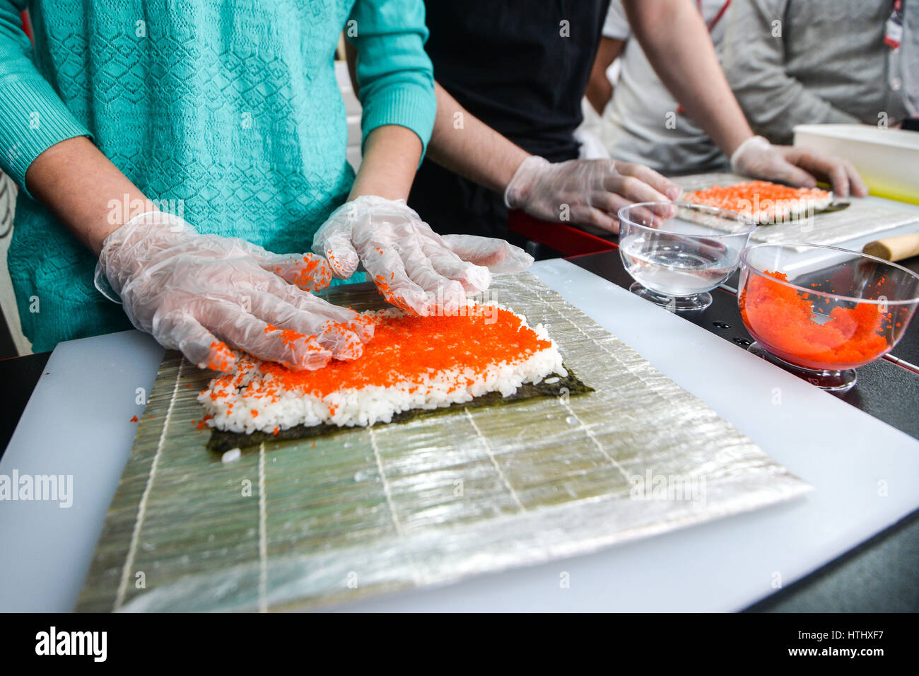 Human hands cooking sushi rolls hi-res stock photography and images - Alamy