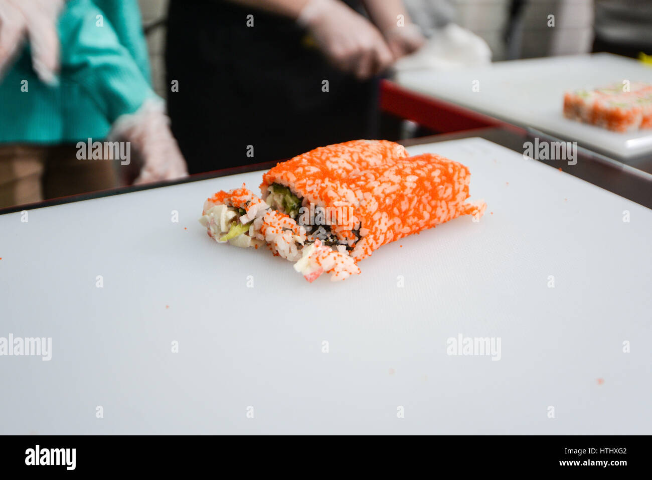 Human hands cooking sushi rolls hi-res stock photography and images - Alamy