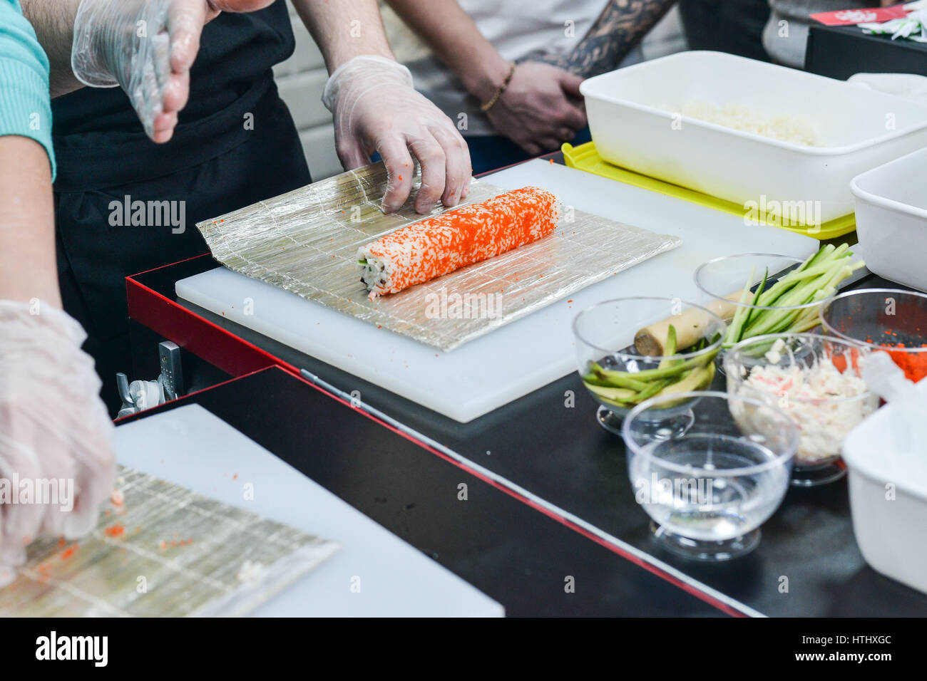 Human hands cooking sushi rolls hi-res stock photography and images - Alamy