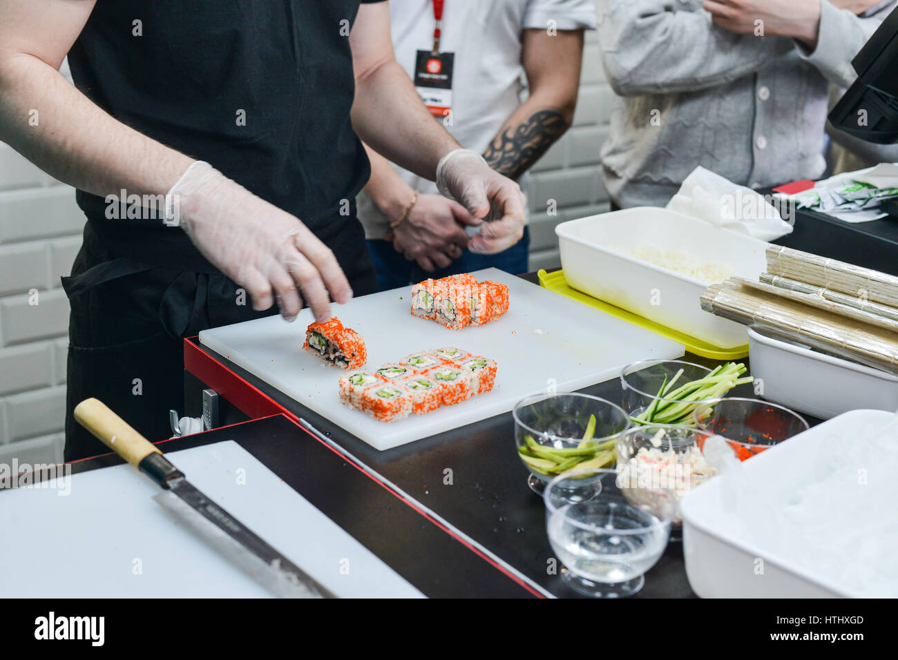 Human hands cooking sushi rolls hi-res stock photography and images - Alamy