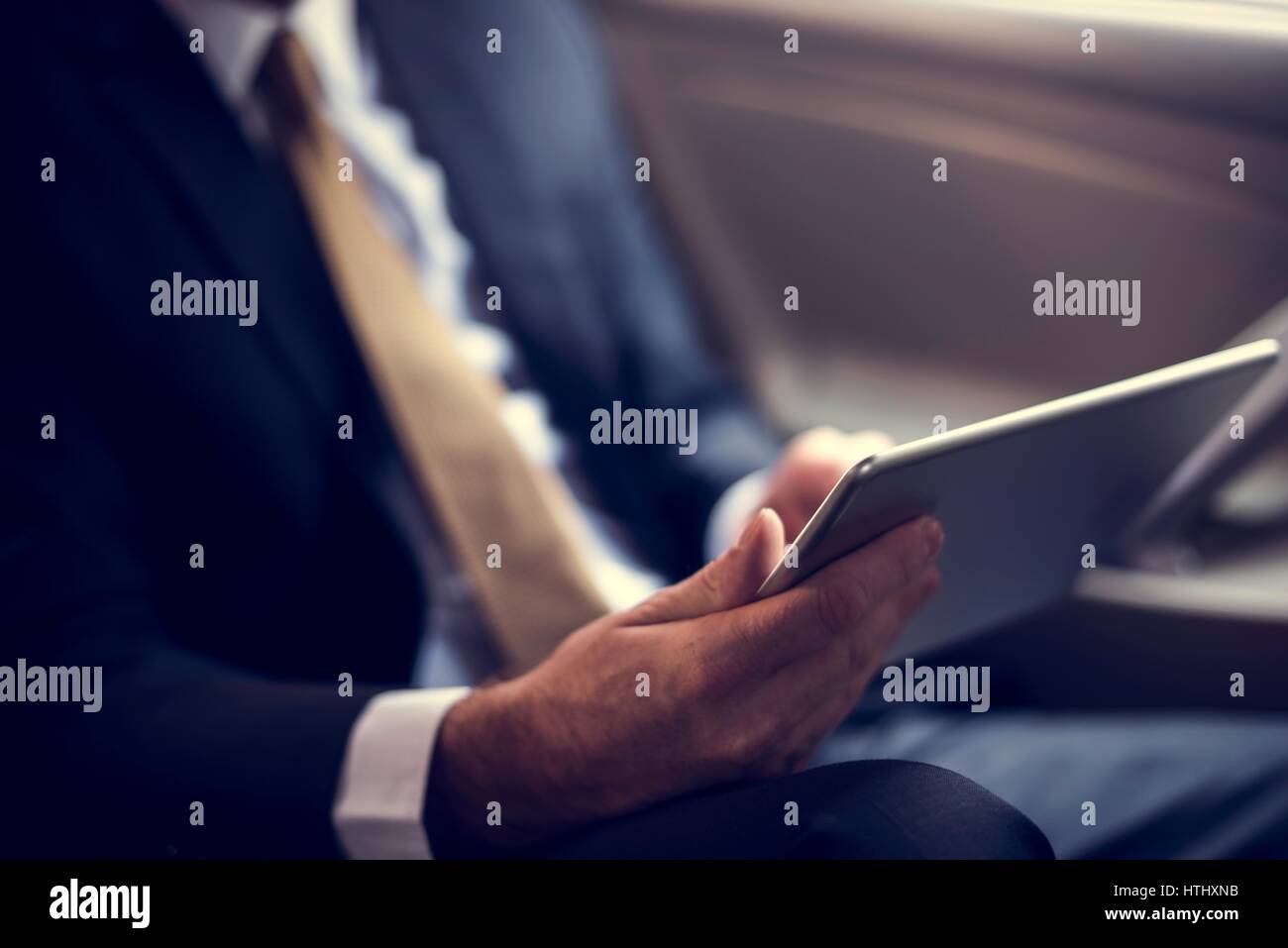 Businessman Using Tablet Working Car Inside Stock Photo - Alamy