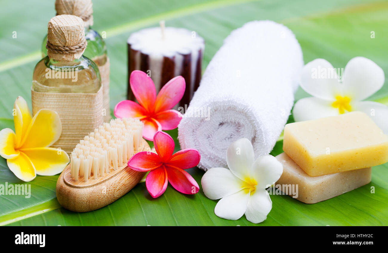 Spa, wellness setting with fresh flowers on a palm leaf background ...