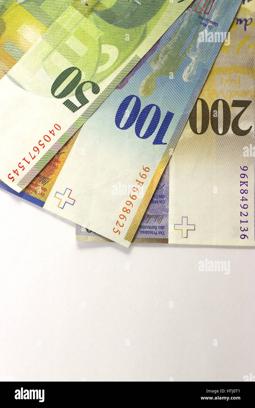 Swiss franc banknotes of different denominations on white background ...