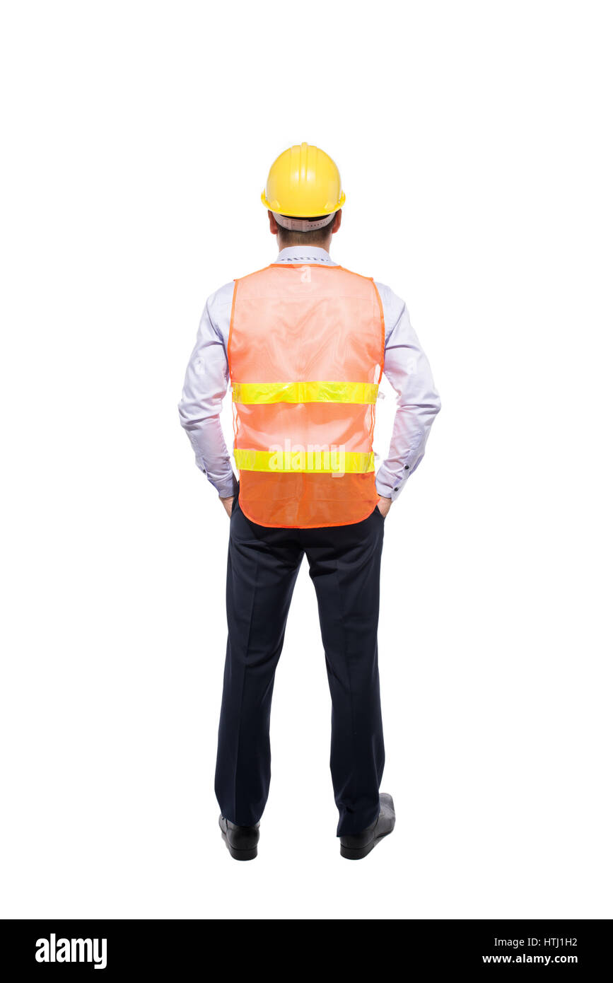 Rear view of architect looking comparing housing project with building ...