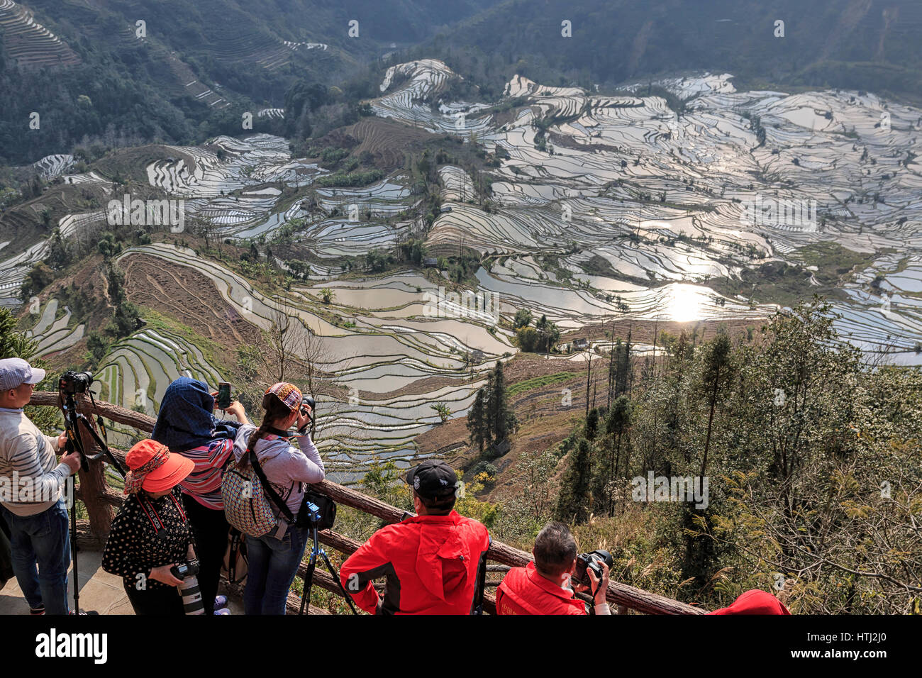 YuanYang, China - February 20, 2017: People watching the sunset over ...