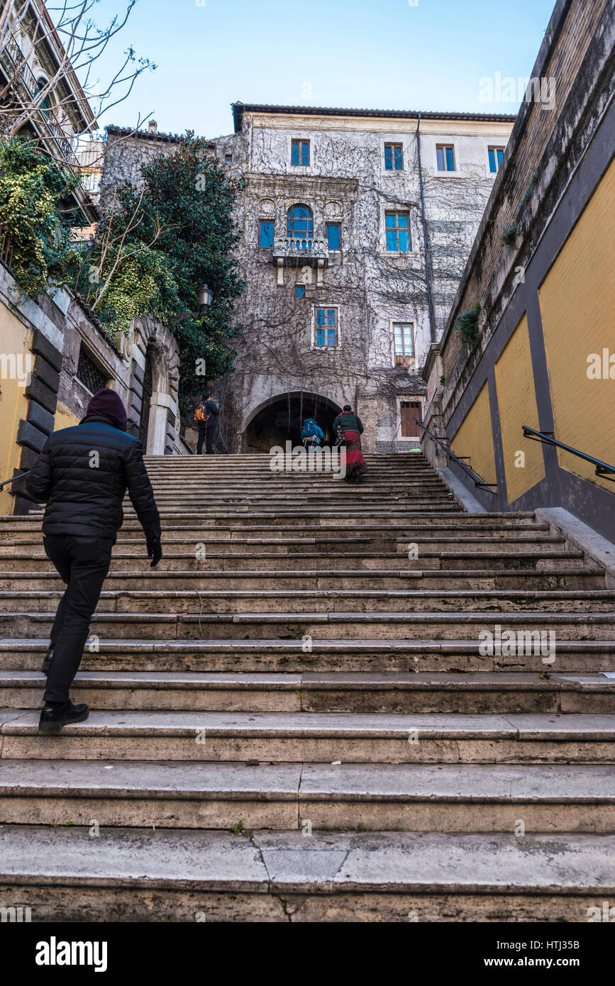 People climbing stairs on a street in the historical center of Rome ...