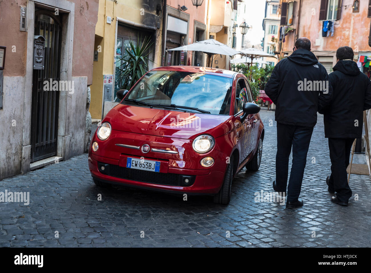 Rome, Italy - January 2, 2017: Red Fiat 500 driving along a street in ...