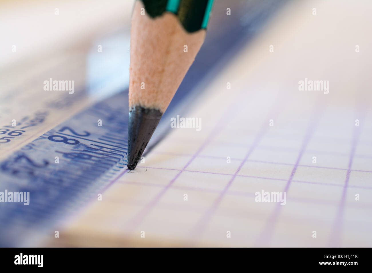 Pencil drawing a line at ruler. Shallow depth of field Stock Photo - Alamy