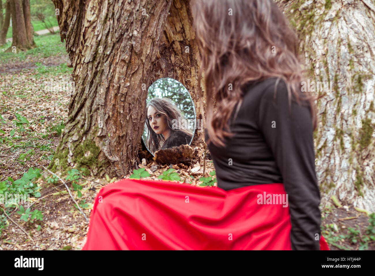 mystical woman looks in the mirror Stock Photo - Alamy