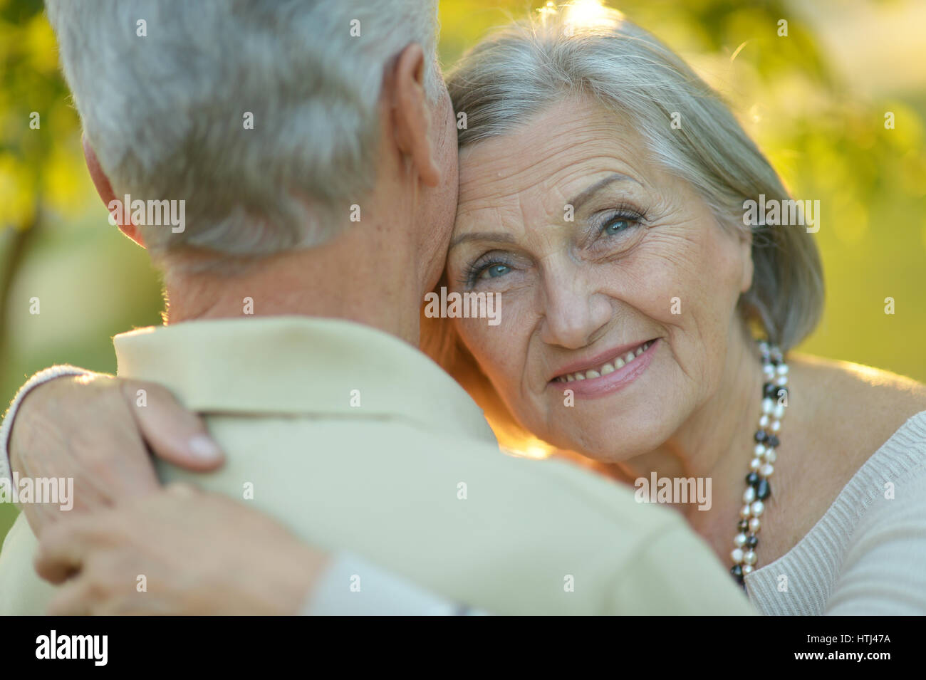Portrait of a happy elderly couple embracing Stock Photo - Alamy