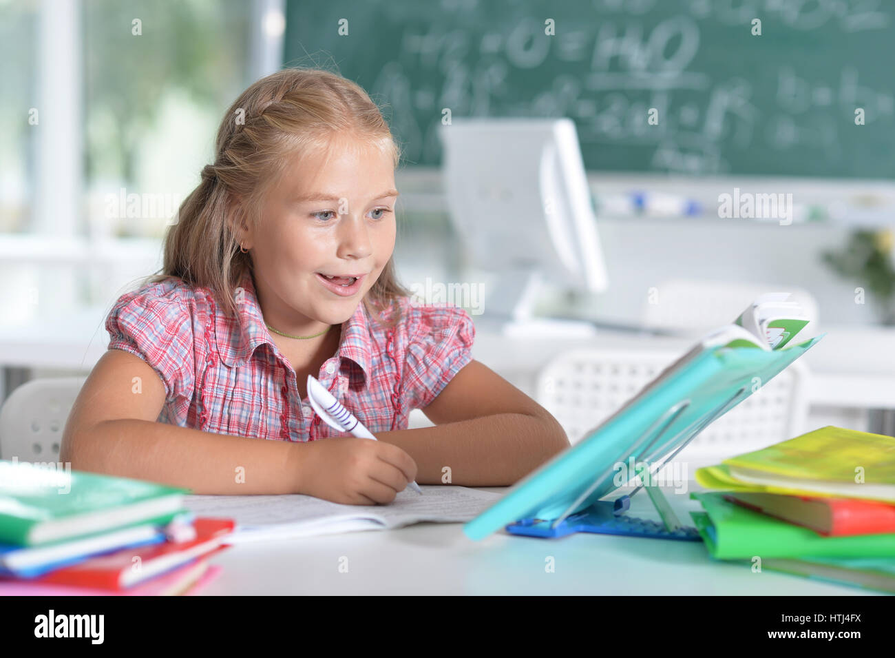 Portrait of a cute girl does lessons Stock Photo - Alamy