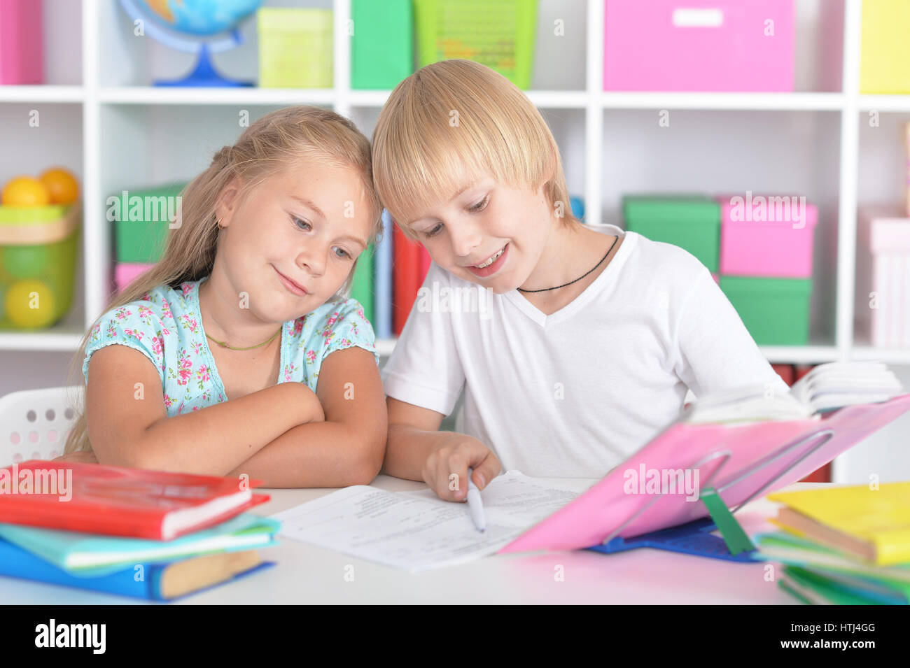 Portrait of girl and boy doing lessons Stock Photo - Alamy