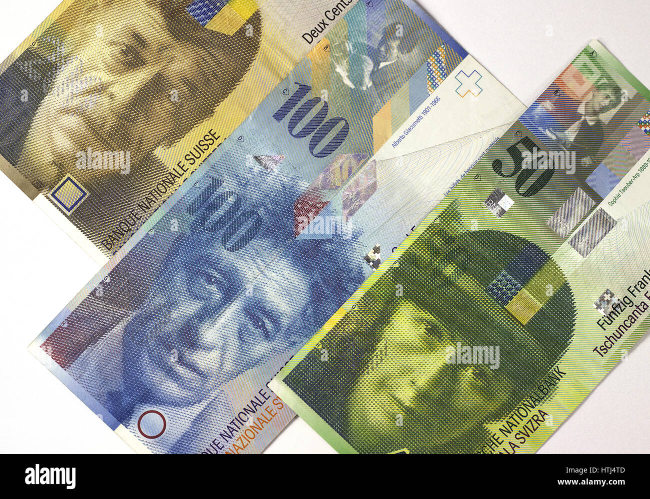 Swiss franc banknotes of different denominations on white background ...