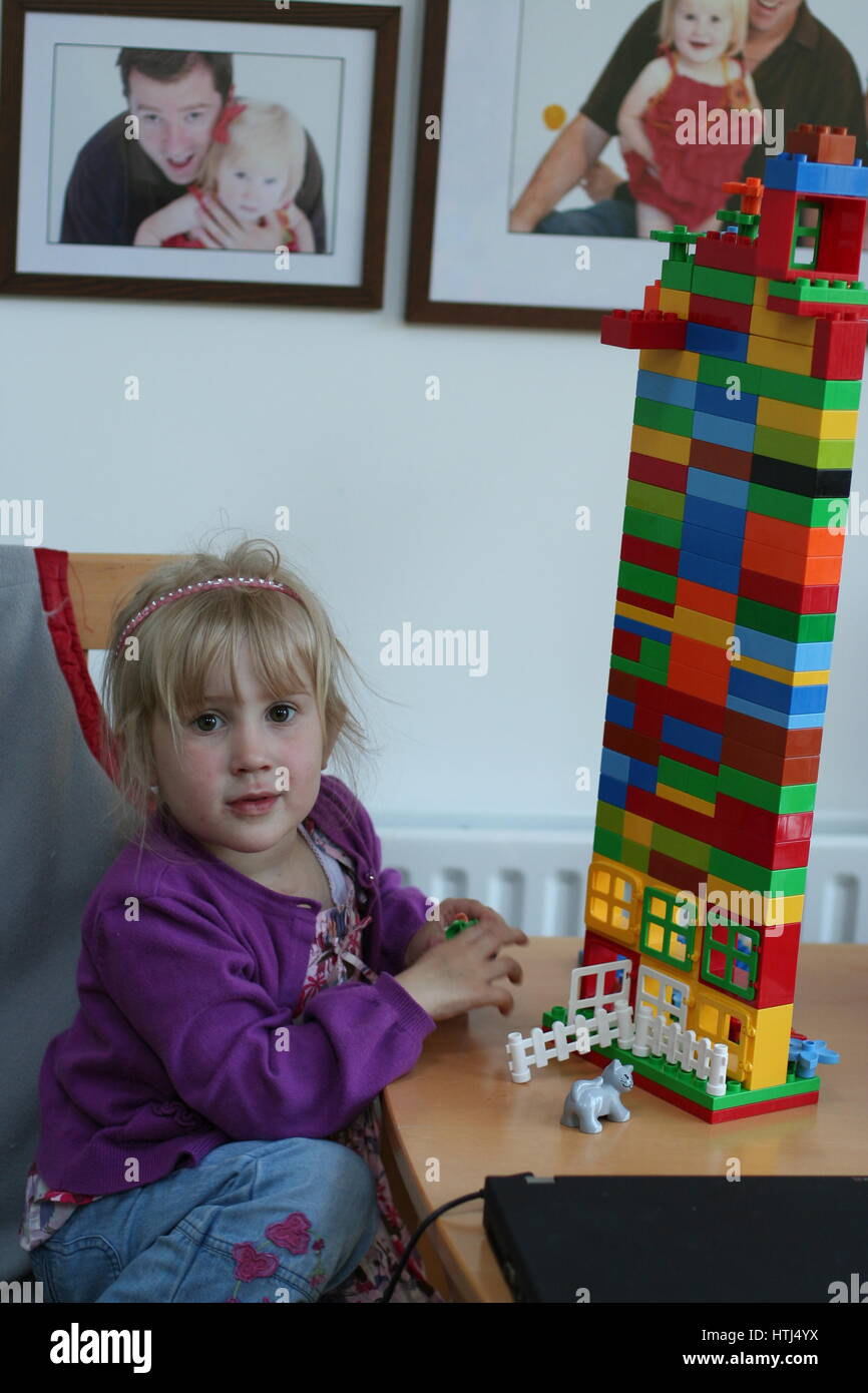 Little girl making a lego tower ambition achievement Stock Photo - Alamy
