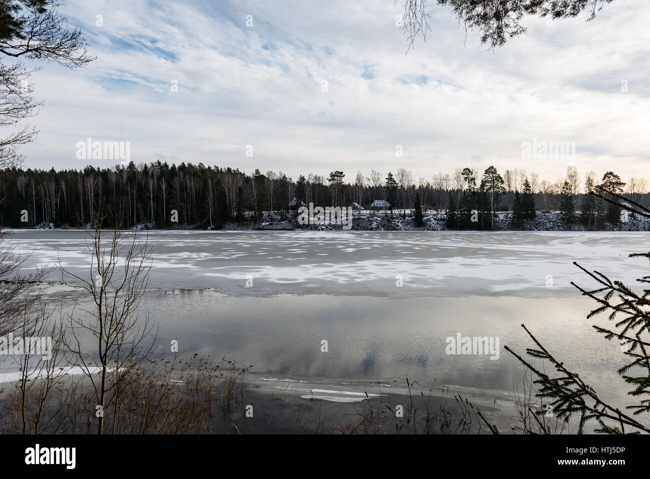frozen countryside scene in winter with snow. iced river with blocks of ...