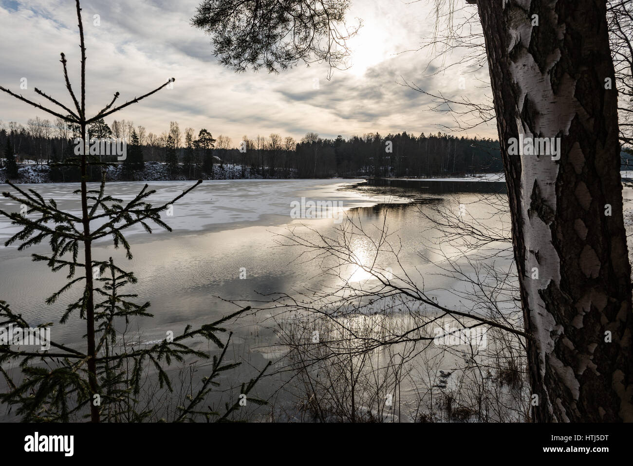 frozen countryside scene in winter with snow. iced river with blocks of ...