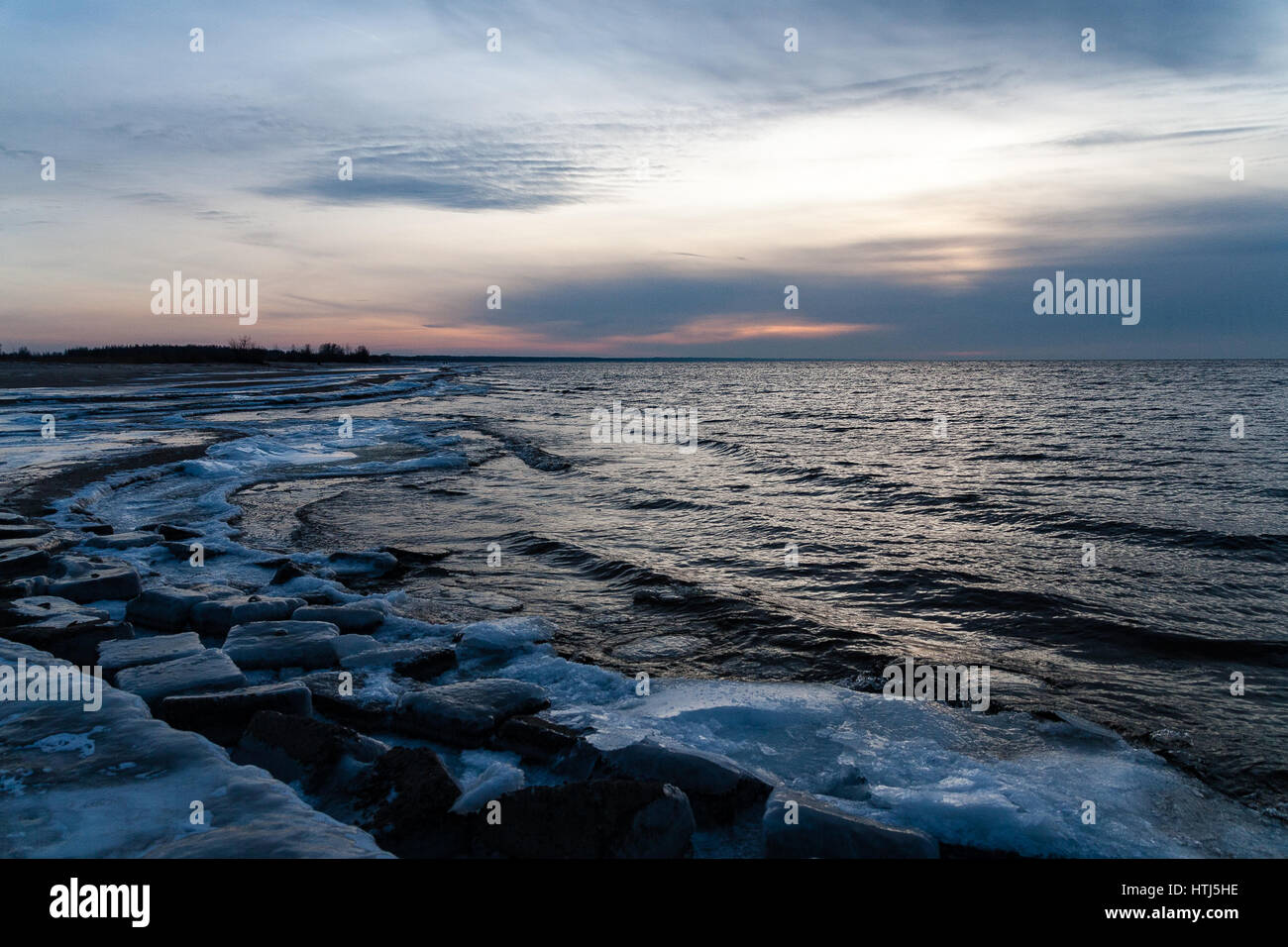 frozen countryside scene in winter with snow. beach scene with ice ...