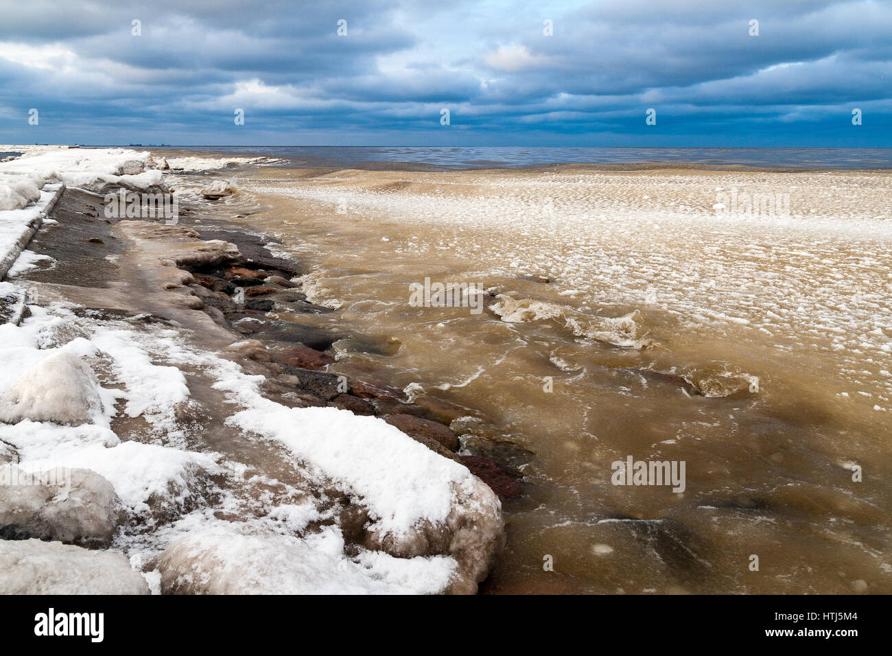 frozen countryside scene in winter with snow. beach scene with ice ...