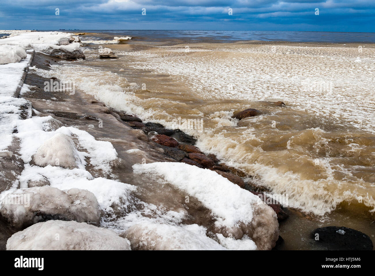 frozen countryside scene in winter with snow. beach scene with ice ...
