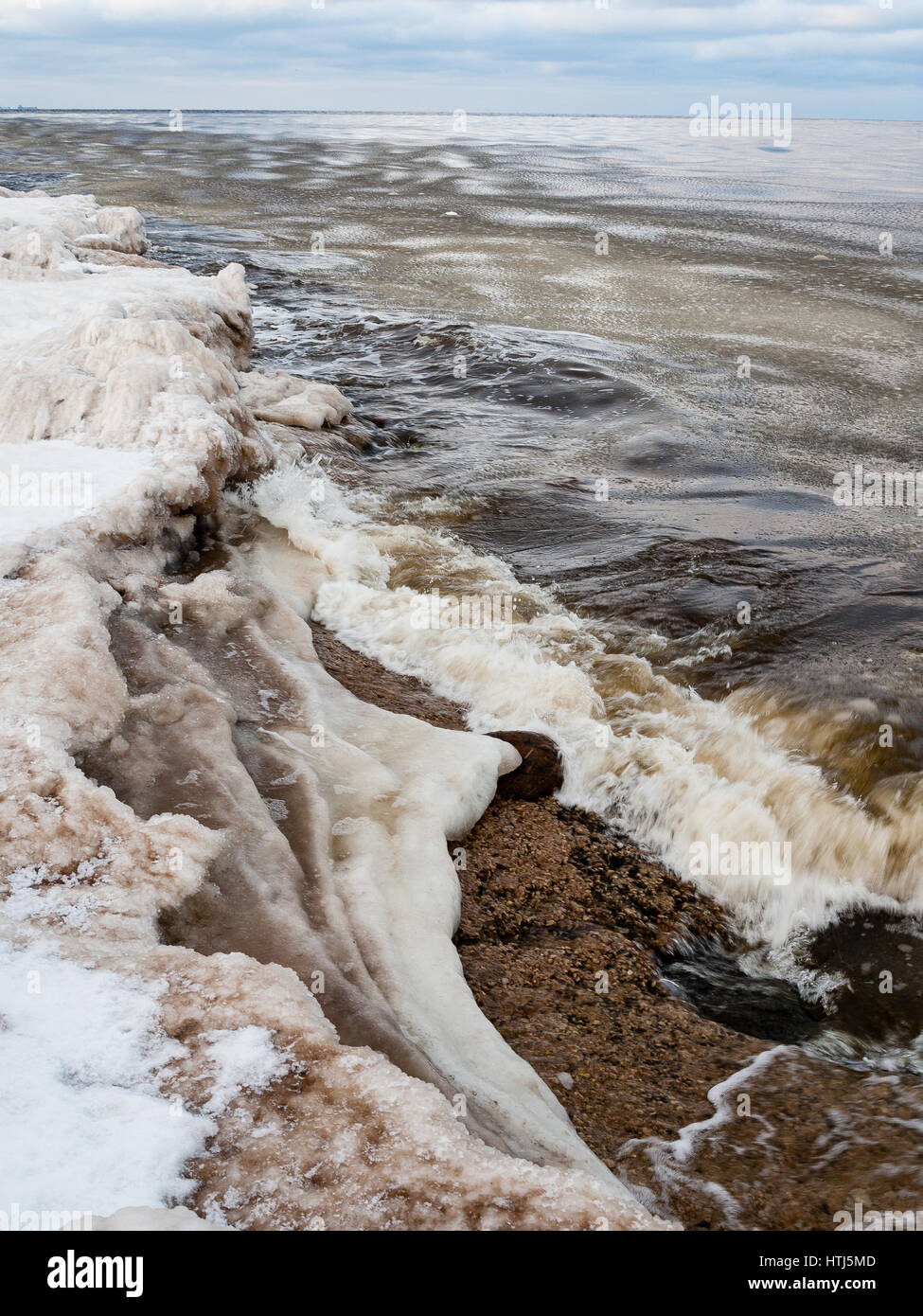 frozen countryside scene in winter with snow. beach scene with ice ...