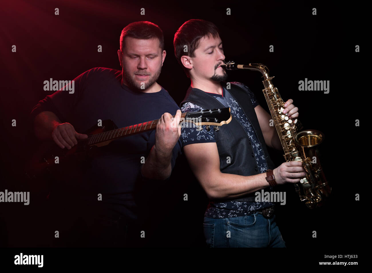 Two musicians on a black background Stock Photo - Alamy