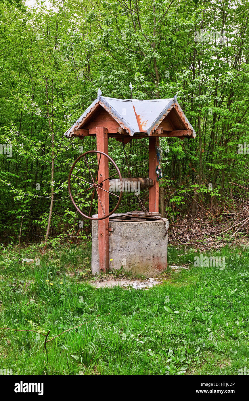 An old wooden well in the forest Stock Photo - Alamy